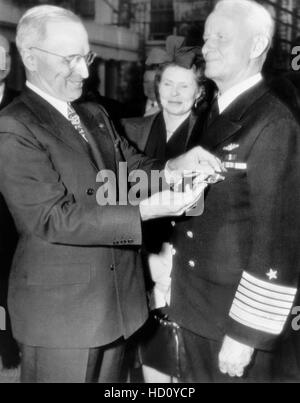 President Harry Truman, left, decorating Fleet Admiral Chester Nimitz, while Catherine Nimitz ...