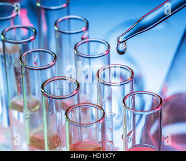 Different laboratory glassware with color liquid on laboratory ...