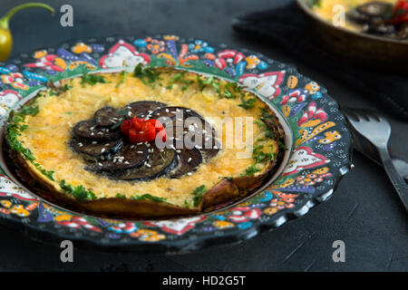 frittata with red onion, eggplant, tomato sprinkled with parsley on ...