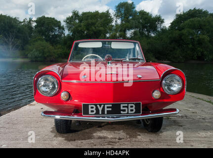 Amphicar - the 1960s amphibious swimming car driving out of a lake ...