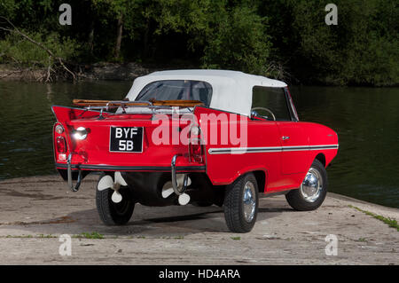 Amphicar - the 1960s amphibious swimming car driving out of a lake ...