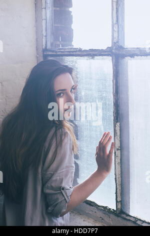 Sad young woman hand touching the window Stock Photo - Alamy