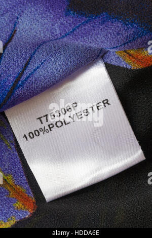 100% polyester label in woman's red clothing with wash care symbols and ...