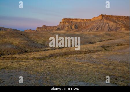 The sun sets over the Book Cliffs mountain range at the Book Cliffs ...