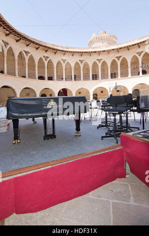 Bellver castle interior scene with grand piano and seats on a sunny ...