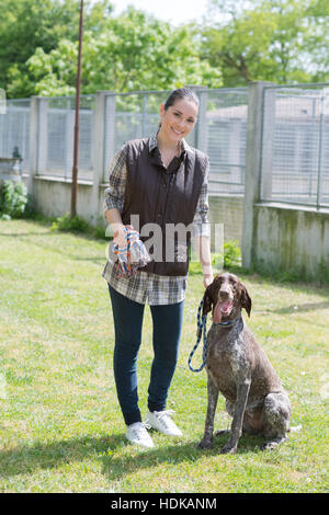 dedicated girl training dog in kennel Stock Photo - Alamy