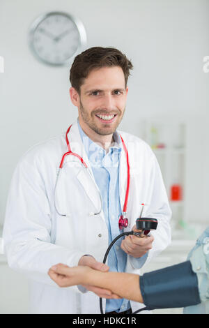 Joyful male doctor checking his patients health Stock Photo - Alamy