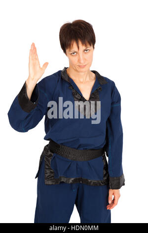 Angry female fighter in kimono looking aside and fighting in studio ...