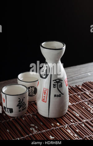 japan sake ceramic botle and cup with black background Stock Photo - Alamy