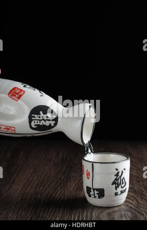 japan sake ceramic botle and cup with black background Stock Photo - Alamy
