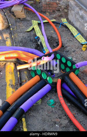 Multicoloured pipes for wiring underground Stock Photo - Alamy