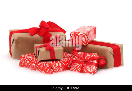 Red gift box against many presents under Christmas tree on floor ...