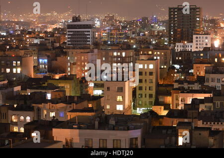Skyline of Tehran, Iran with high rise buildings against snow capped ...