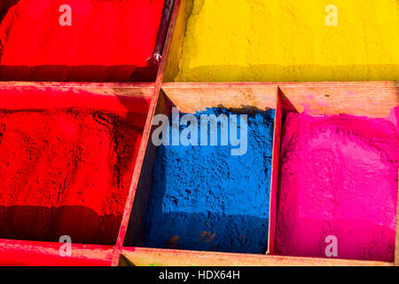 close up yellow powder color on wooden spoon. colourful powder paint in ...