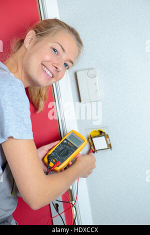 female electrician using multimeter to test spotlight Stock Photo - Alamy