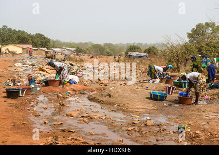 Two African women washing clothes by hand in buckets. Accra, Ghana ...