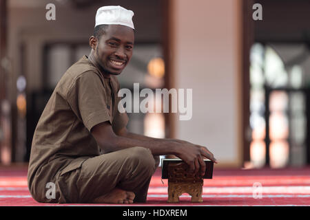 Black African Muslim Man Reading Holy Islamic Book Koran Stock Photo ...