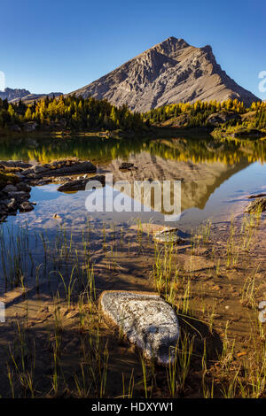 Fossil Mountain rises above Little Baker lake in the Skoki Wilderness ...