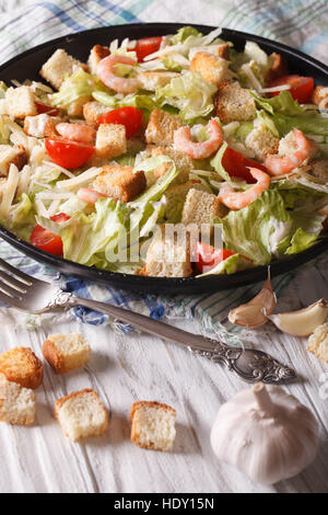 Plate with delicious Caesar salad on color wooden background, closeup ...