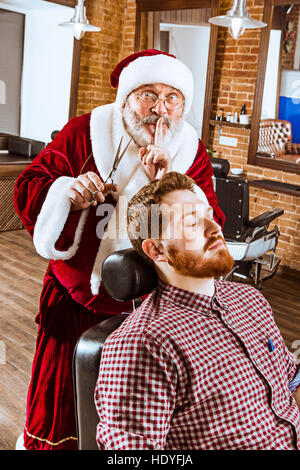 Santa claus as master at barber shop Stock Photo - Alamy