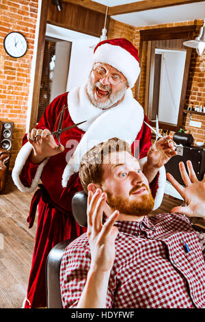 Santa claus as master at barber shop Stock Photo - Alamy