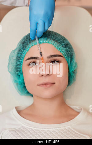 Woman receiving cosmetic injection through nose Stock Photo - Alamy