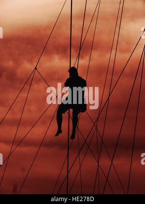 A person setting sail on a yacht as the sun sets over the horizon of ...