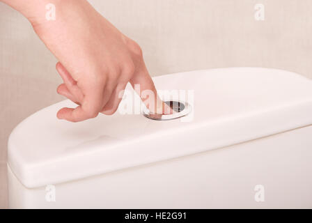 Children hand flushing toilet. Space available on left-hand and right ...