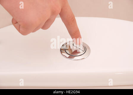 Children hand flushing toilet. Space available on left-hand and right ...
