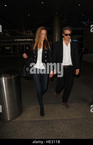 Hugh Grant arrives at the airport with his partner Featuring: Hugh ...