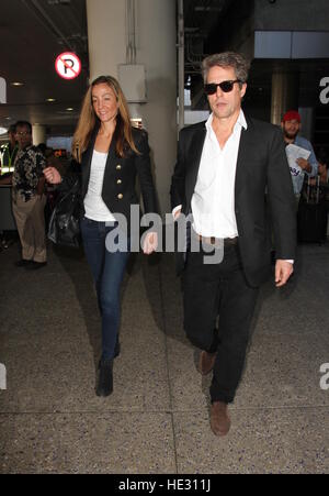 Hugh Grant arrives at the airport with his partner Featuring: Hugh ...