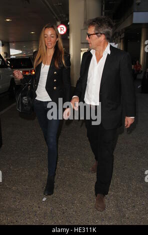 Hugh Grant arrives at the airport with his partner Featuring: Hugh ...