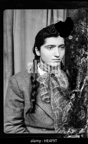 Portrait of a Romanian girl in traditional costume holding a lavender ...