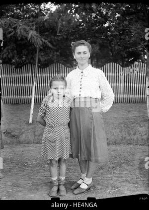 A photograph of a mother with her child, captured in Romania during the ...