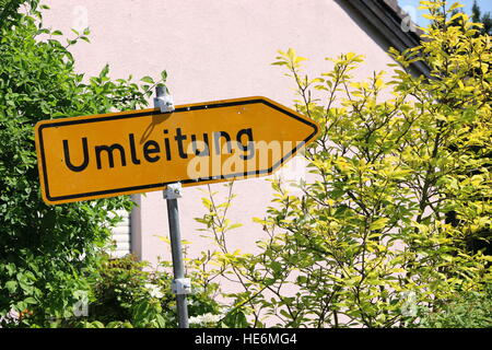 Yellow German arrow road sign pointing to left and saying "route ...