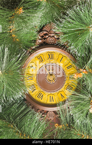 New Year clock and fir branch with decoration and snowflakes background ...