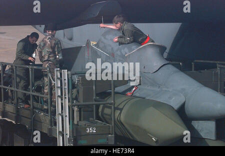Munitions personnel, on a B-52 pylon maintenance/loading stands, from ...