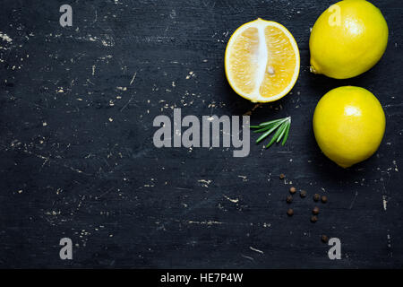 Fresh rosemary and lemons on dark background Stock Photo - Alamy
