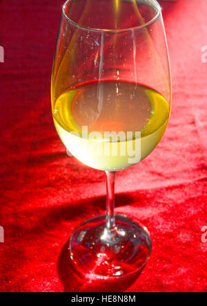 White wine in glass on room background Stock Photo - Alamy