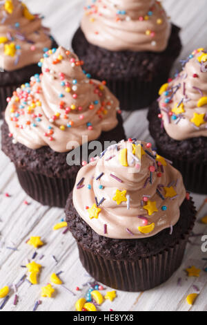 Baked cupcakes with white butter cream on the table, delicious dessert ...