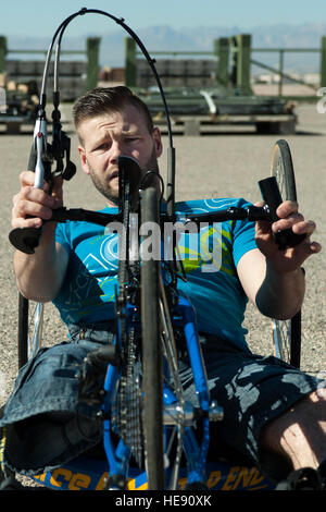 A member of the Air Force Cycling Team poses for a photo while riding ...