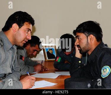 An Afghanistan national police officer helps U.S. Army 2nd Lt. Jonathon ...