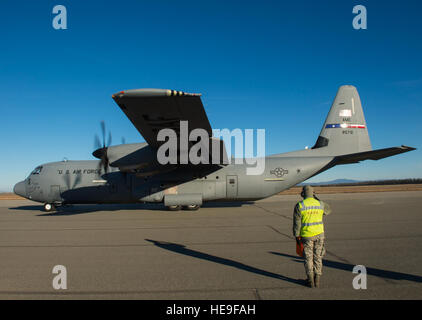 A U.S. Air Force marshalling Airman turns his back to avoid the ...