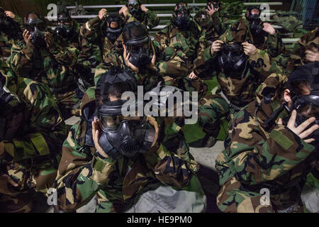 Airmen don their M50 Joint Service General Purpose Masks as they brush ...