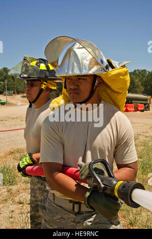 A U.S. Air Force firefighter, medic, and police officer stand at ...