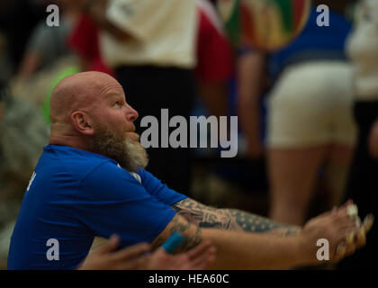 Air Force athlete Keith Sekora points something out to his sitting ...