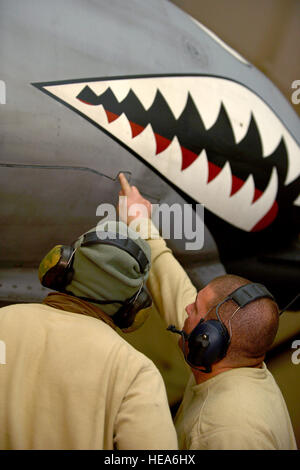 Air Force personnel perform maintenance on a Tunner 60K aircraft cargo ...