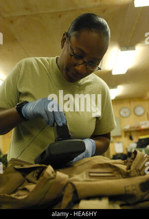 An aircrew flight equipment Airman from the 33rd Rescue Squadron uses a ...