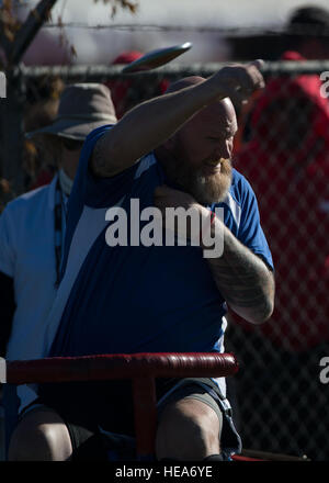 Air Force athlete Keith Sekora holds up bow pieces during the archery ...