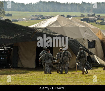 U.S. Army Soldiers litter transport a simulated injured patient to the ...